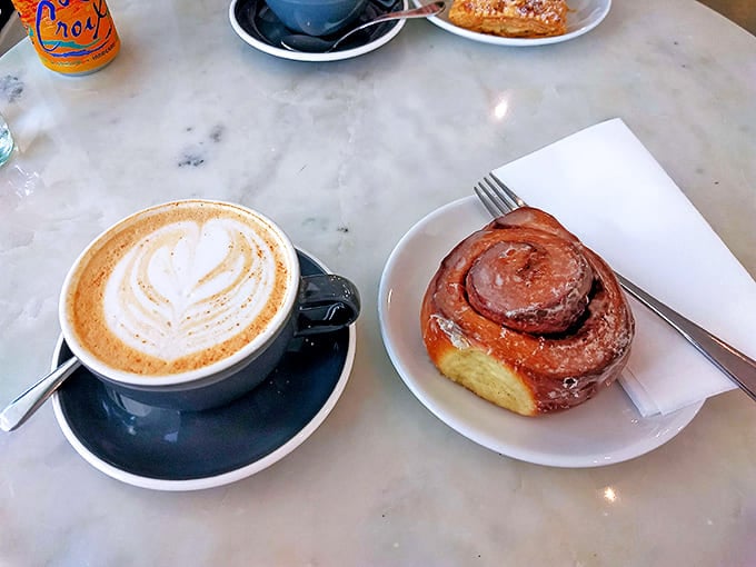 The perfect spiral of this cinnamon roll suggests the baker might have studied mathematics. The latte art proves they definitely studied deliciousness.