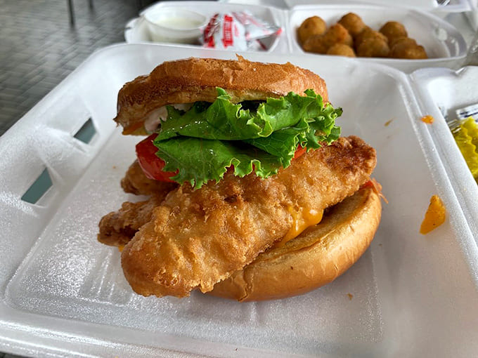 Cod sandwich that would make fishermen proud: Flaky white fish in a golden crust nestles between fresh lettuce and tomato on a perfectly toasted bun.