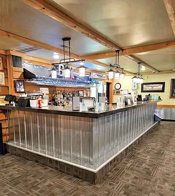 The bar area strikes that perfect balance between rustic and refined, where strangers become friends over well-crafted drinks.