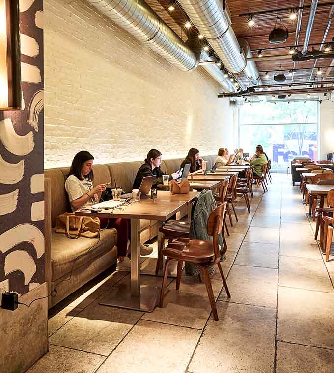 The bright, modern interior with exposed brick and industrial touches creates that perfect coffee shop vibe where time slows down and breakfast tastes better.