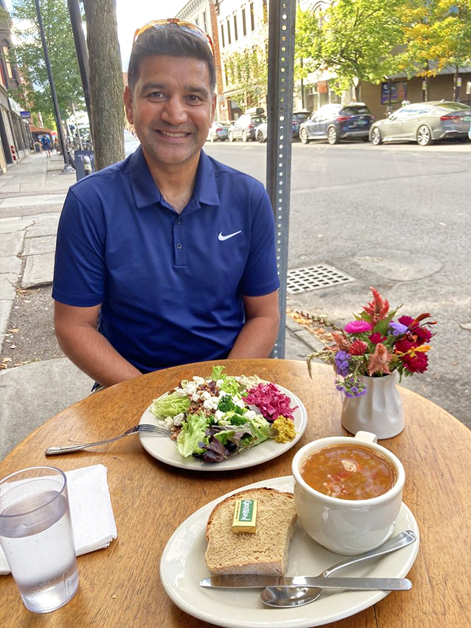 A diner enjoys the perfect pairing &ndash; a vibrant salad and soul-warming soup, served with the crusty bread that Burlington locals have come to crave.