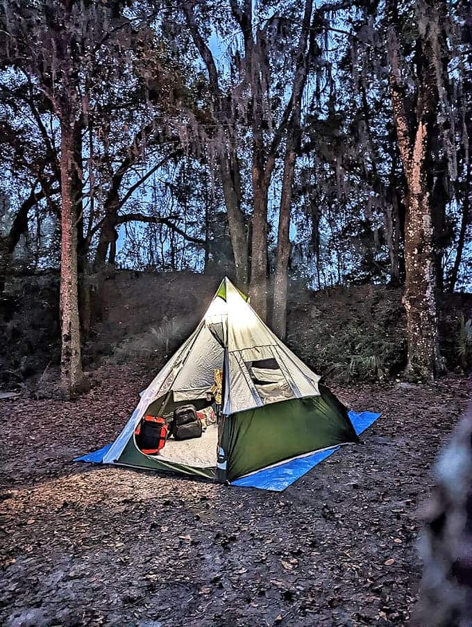 As darkness falls, this tent glows like a paper lantern among ancient trees &ndash; camping at Devil's Den is pure magic.