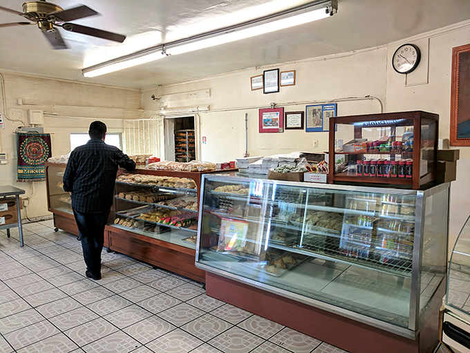 Customers browse the day's offerings, participating in a ritual that connects them to both Mexican culture and the local Tucson community.
