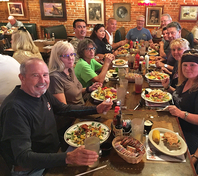 Happy faces around a table loaded with Stumpknockers' finest &ndash; proof that good food creates great memories and brings people together.