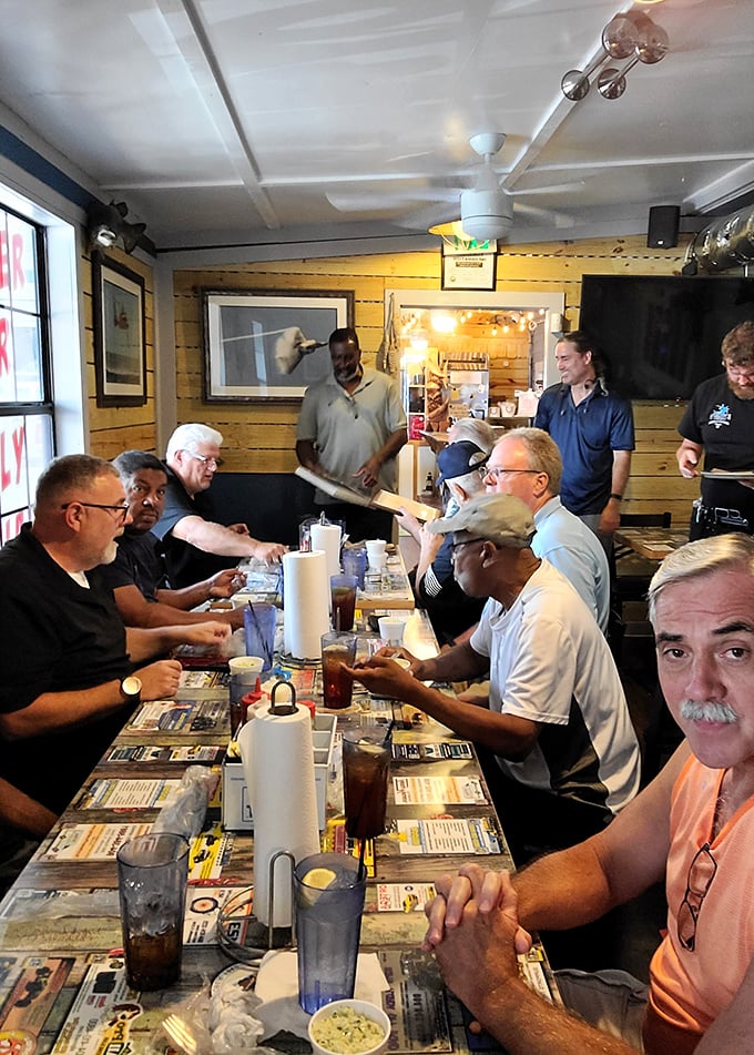 Where seafood brings strangers together &ndash; notice how everyone's leaning in, as if sharing delicious secrets over their meals.