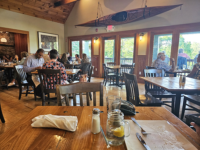 Happy diners bask in the warm glow of the dining room, where wooden accents and large windows create Maine's quintessential eating experience.