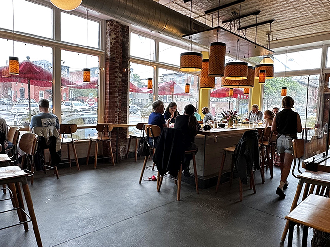 The communal table buzzes with the energy of strangers becoming friends over shared plates and the universal language of "you've got to try this."