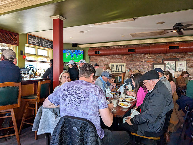Weekend warriors gather around tables, united in their quest for the perfect brunch experience while sports play quietly on the bar TV.
