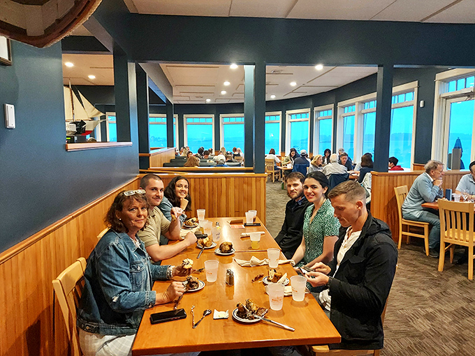 Happy diners experiencing that moment when conversation stops and appreciation begins &ndash; the universal language of great food.