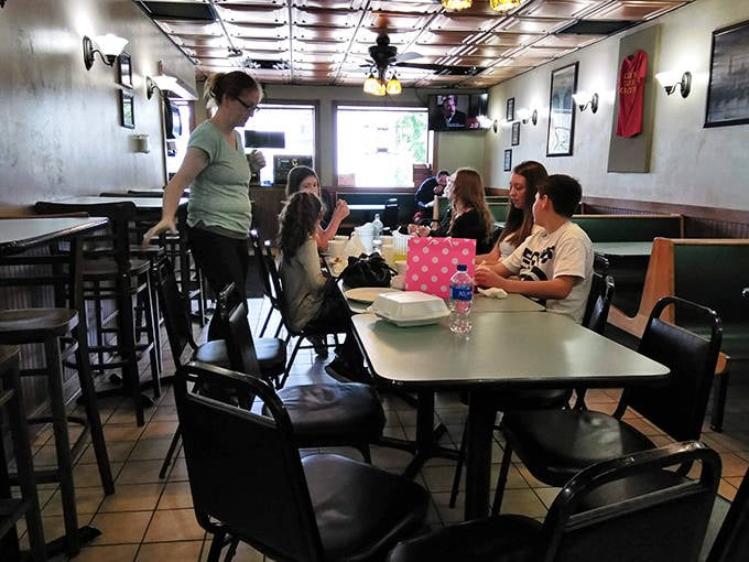 The outdoor seating area offers desert views and people-watching opportunities under the shelter of those signature red awnings.