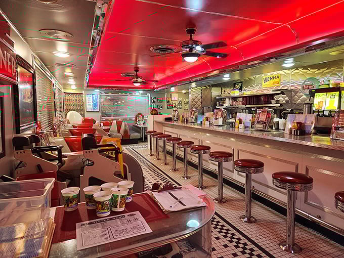 The main dining room's cherry-red ceiling and vintage booths create the perfect backdrop for breakfast conversations that stretch into lunchtime.