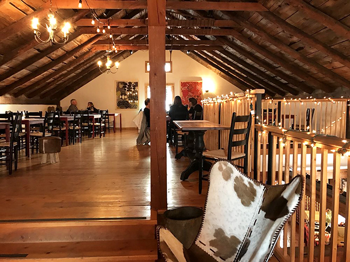 The charming loft dining area, with its exposed beams and twinkling lights, creates an atmosphere that's simultaneously rustic and romantically refined.