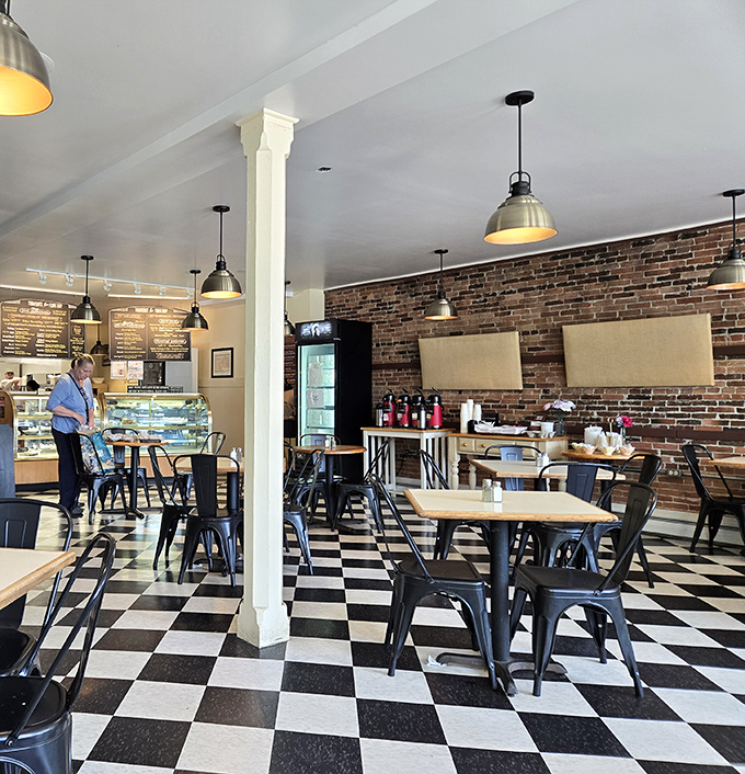The dining area balances rustic charm with clean simplicity &ndash; those metal chairs and wooden tables creating the perfect stage for culinary performances.