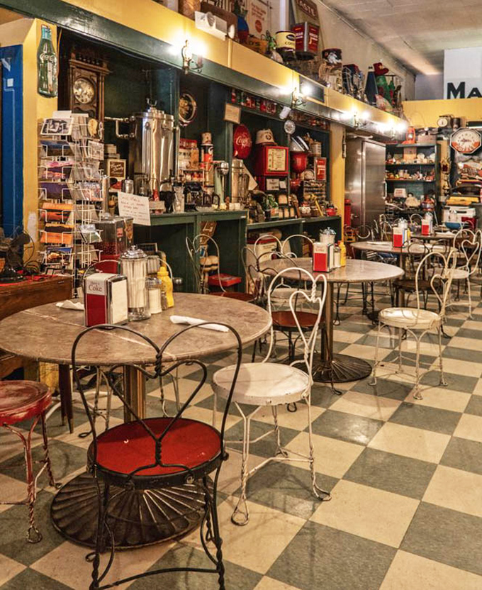 The dining area feels like stepping into a beloved relative's kitchen, if that relative collected charming vintage memorabilia for decades.