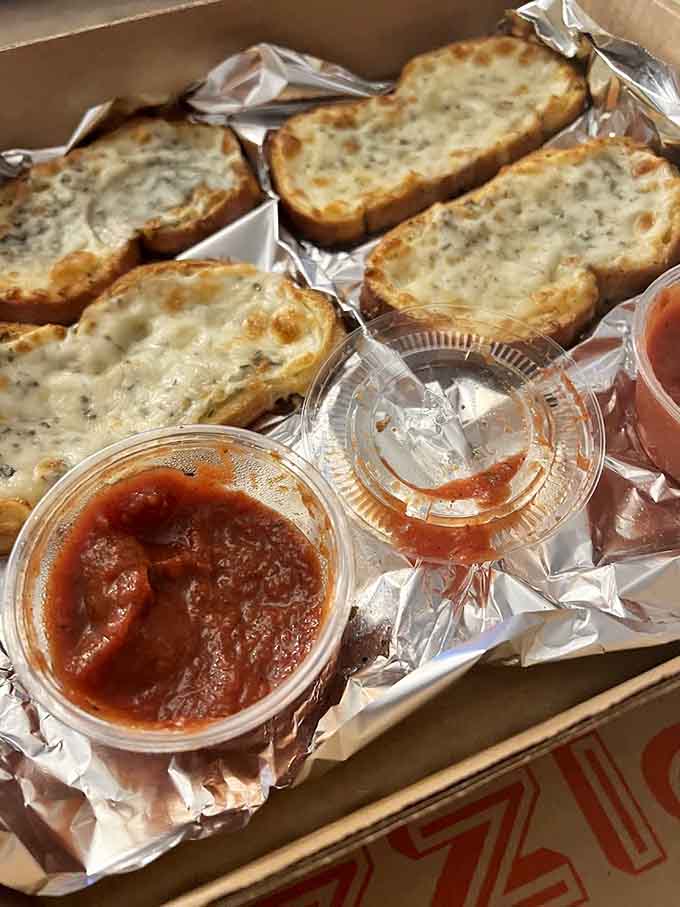 Garlic bread that's been buttered and toasted until it's basically edible gold, served with marinara for dipping.