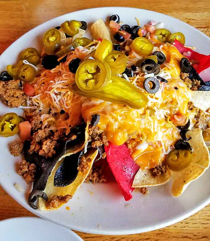 These nachos don't mess around, arriving loaded with toppings that actually reach every chip instead of abandoning the bottom layer.
