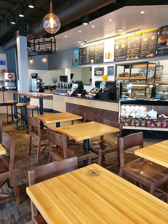 Clean lines, wooden tables, and exposed ceiling ducts create a contemporary space where lingering over breakfast feels like the right thing to do.