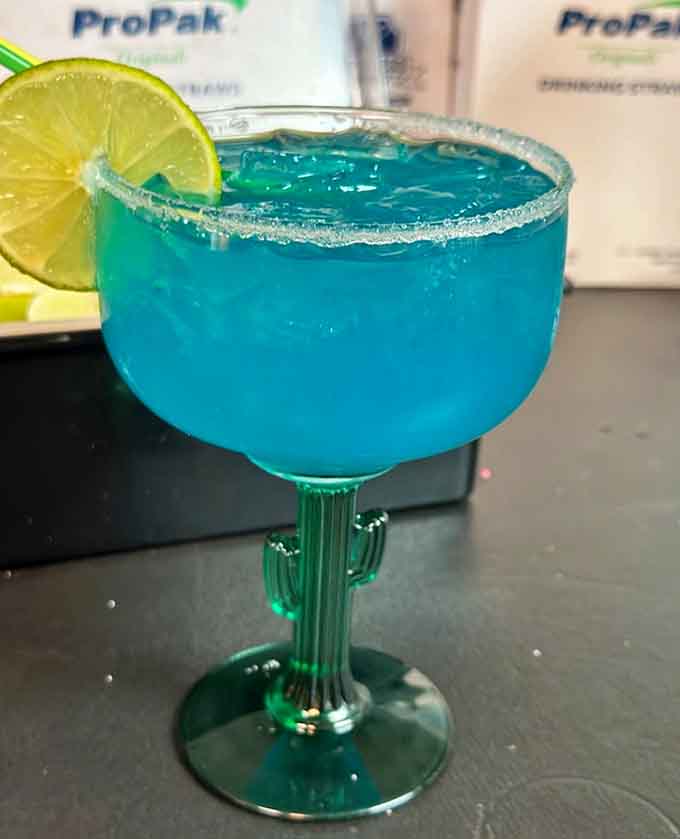 That electric blue margarita in a cactus-shaped glass is almost too pretty to drink, but you'll get over that quickly.