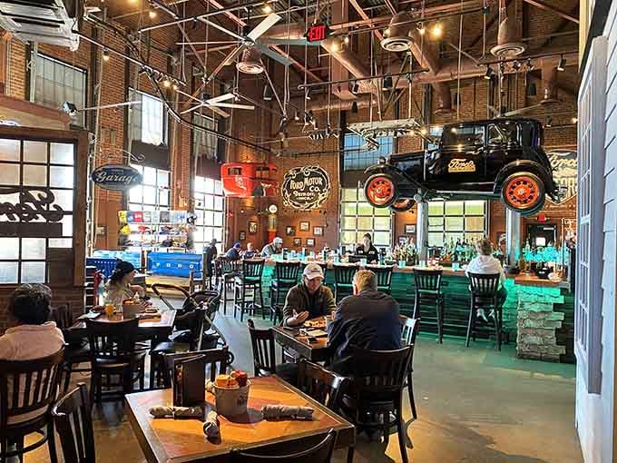 Diners enjoy their meals surrounded by classic Ford signage and industrial charm, making every burger taste a little more special.