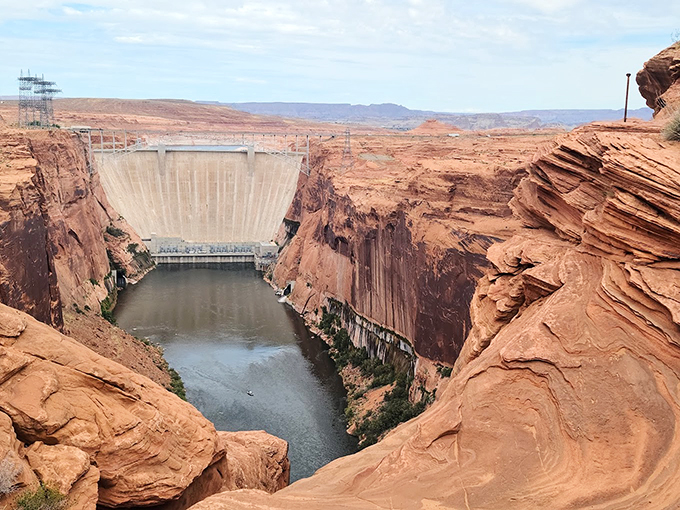 Engineering meets nature in perfect harmony: the massive Glen Canyon Dam stands proud against its red rock canvas.