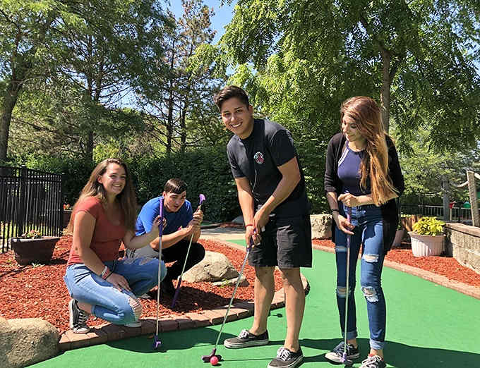 Mini-golf masters in training tackle the course with determination, proving precision sometimes trumps speed for family fun.