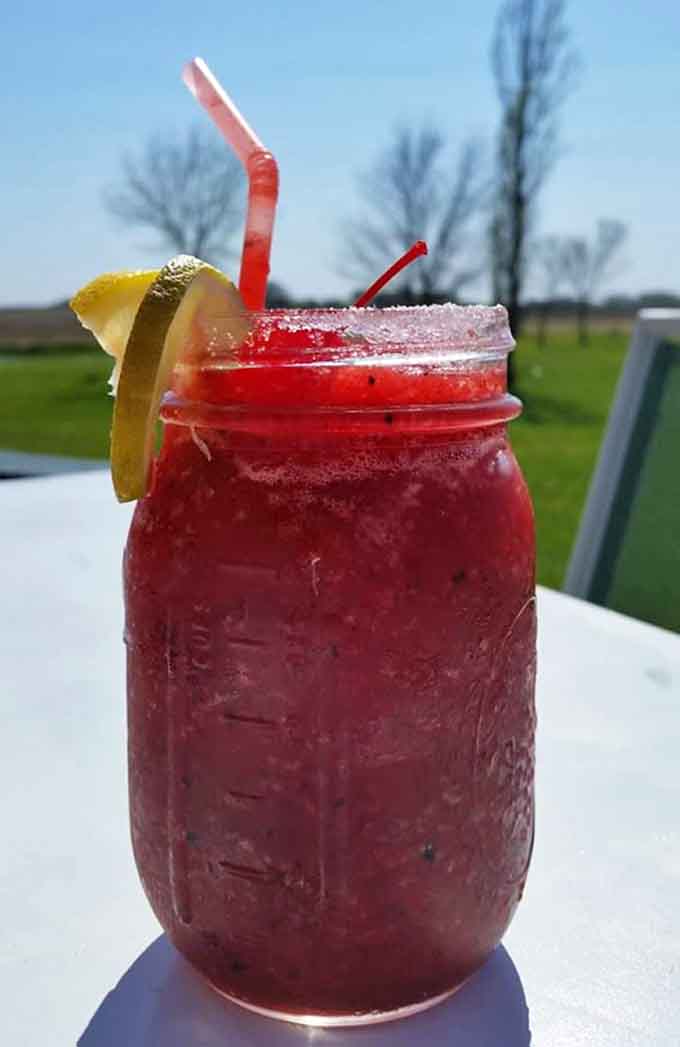 This ruby-red refresher in a mason jar looks like summer tastes, complete with a lemon smile and enough ice to keep things cool.