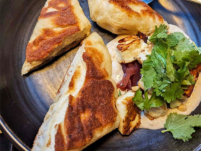 Flatbread with the perfect char marks, its pillowy interior and thoughtful toppings demonstrating that great bread is the foundation of memorable dining.