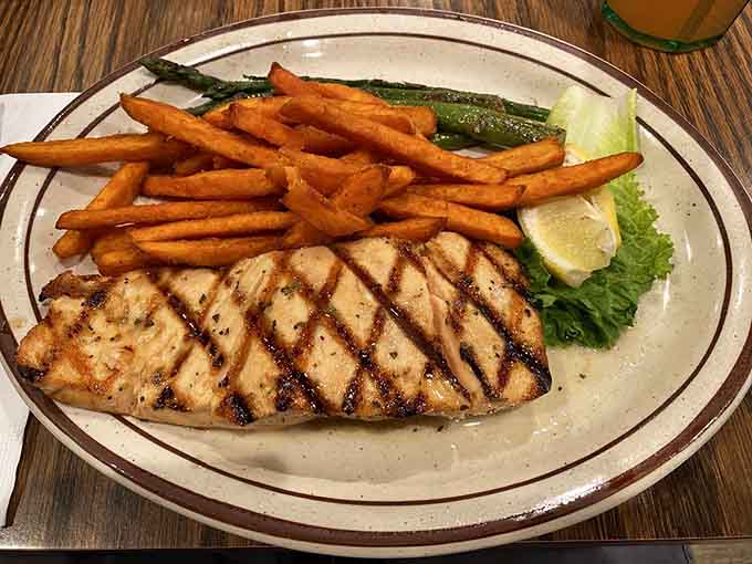 Grilled salmon with perfect char marks and a side of vegetables shows that landlocked Arizona can still serve quality seafood dishes.