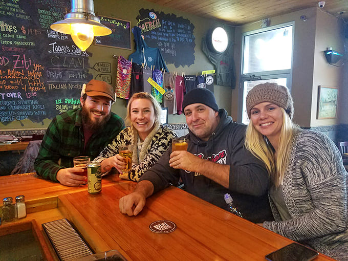 Happy diners raise their glasses in a toast, capturing the convivial spirit that makes the Gunflint Tavern more than just a restaurant.