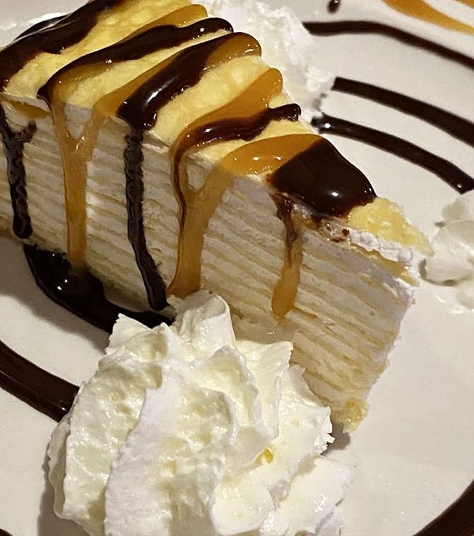 Layers upon layers of crepe cake drizzled with chocolate and caramel sauce make you understand why some people skip straight to dessert.