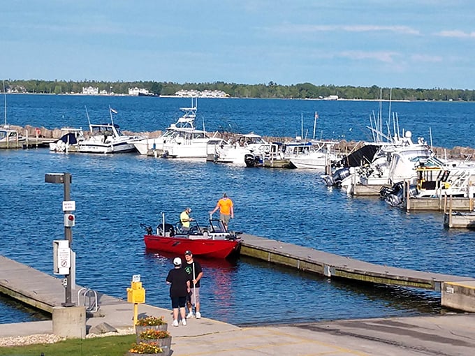 Boats bob gently in the harbor as visitors explore the docks, a perfect launching point for Lake Michigan adventures.