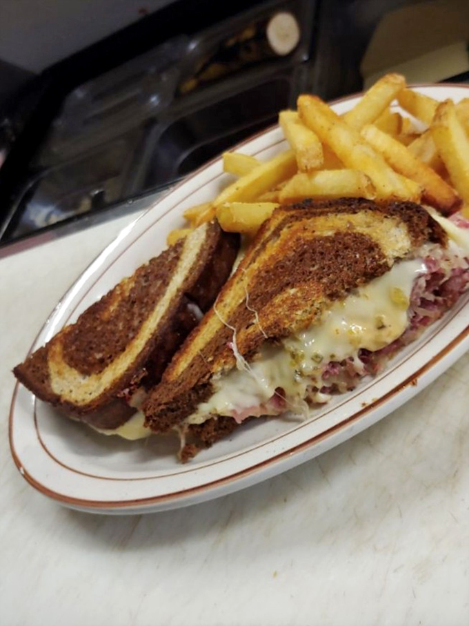 The Reuben sandwich that launched a thousand road trips &ndash; house-made corned beef stacked high between griddled rye that shatters perfectly with each bite.