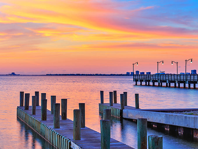 Wooden piers silhouetted against a cotton candy sky &ndash; proof that Florida sunsets aren't just endings, but nature's standing ovation to another perfect day.