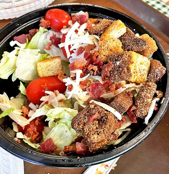 Who said salads can't be exciting? This bowl proves healthy can be hearty with crisp lettuce, bacon, and homemade croutons.