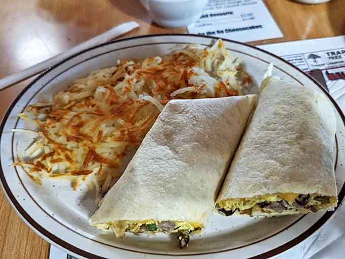 Breakfast Wrap: Morning essentials bundled into portable form &ndash; scrambled eggs, peppers, cheese, and your choice of meat ready for on-the-go adventures.