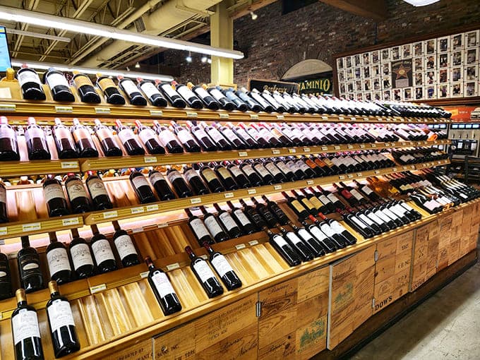 Wine bottles stretch endlessly, offering enough variety to make every dinner party seem woefully under-planned forever.