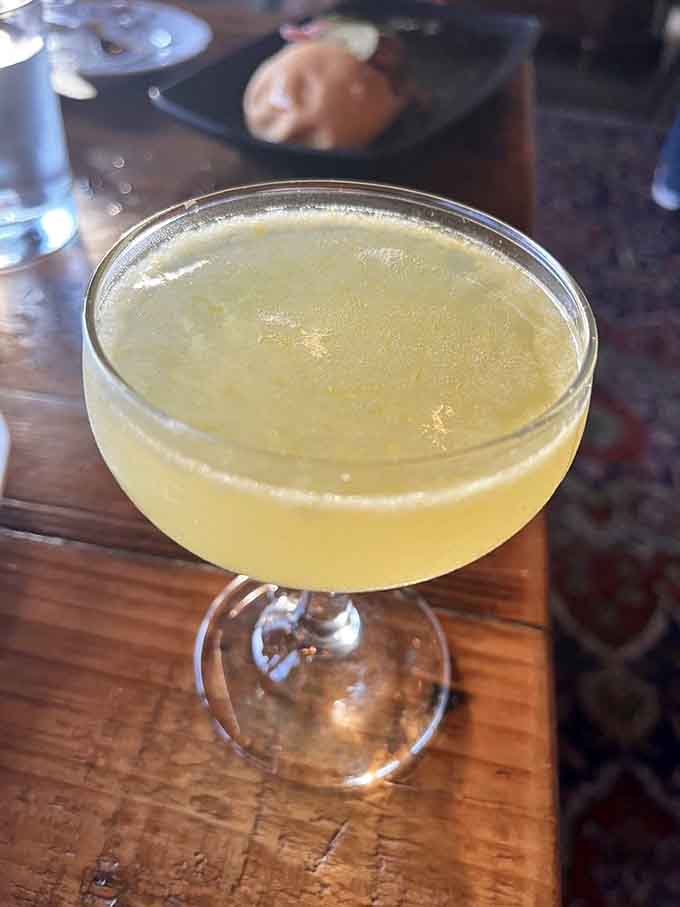 The Tommy #2 cocktail glows like liquid sunshine, tasting as good as it looks in that elegant coupe.