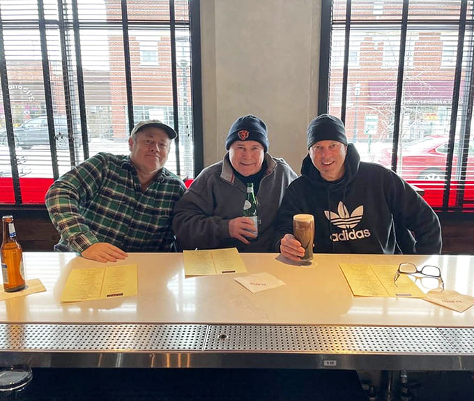 These gentlemen know a good thing when they taste it, settling in for what's clearly a regular tradition.