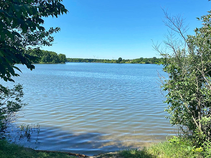 Crystal clear waters stretch to tree-lined shores, offering a peaceful escape from everyday hustle and bustle.