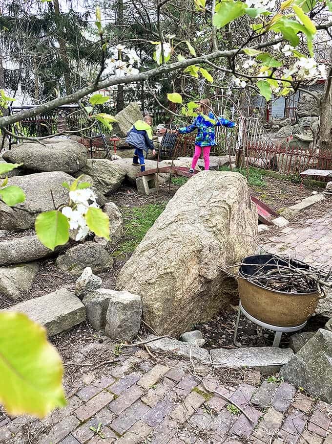 Young explorers discover the joy of climbing and exploring the stone formations, proving that profound spaces can also be playful ones.
