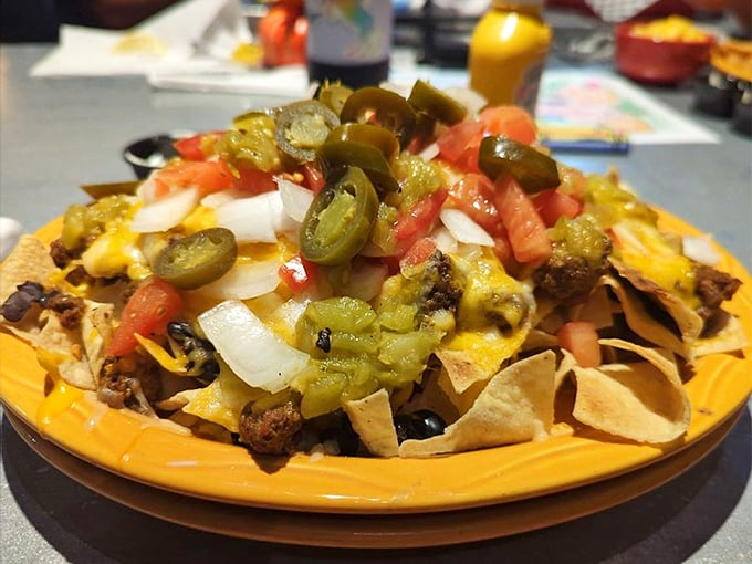 Nachos piled high with all the fixings &ndash; a mountain of flavor that's meant for sharing but too good to actually share.