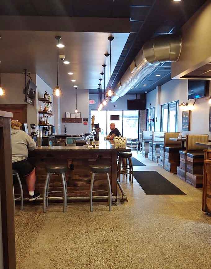 The long bar invites lingering conversations and cold beverages, while booth seating offers cozy corners for serious eating and quality time.