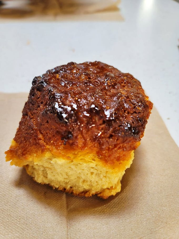 The maple biscuit up close reveals its perfect architecture—crisp exterior giving way to tender interior laced with Vermont's liquid gold.