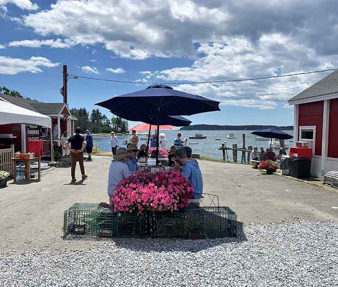 Happy diners enjoying their seafood with a side of stunning harbor views, this is what vacation looks like.