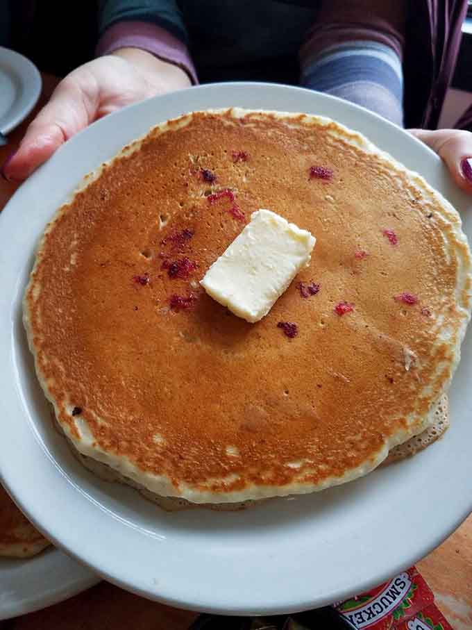 These blueberry pancakes are so fluffy they practically float off the plate, studded with berries like edible jewels.