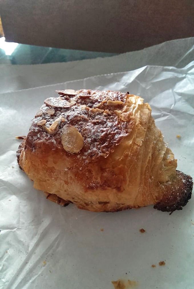 The almond croissant &ndash; where butter meets almond cream in a flaky embrace that makes you momentarily forget your own name.