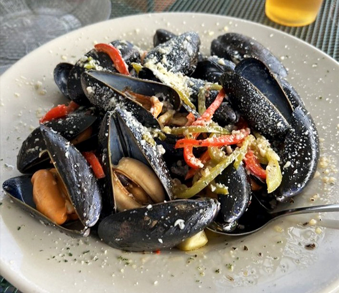 Pan-steamed mussels open like little treasure chests, revealing plump morsels bathed in a garlic-wine sauce worth sopping up with every bread crumb.