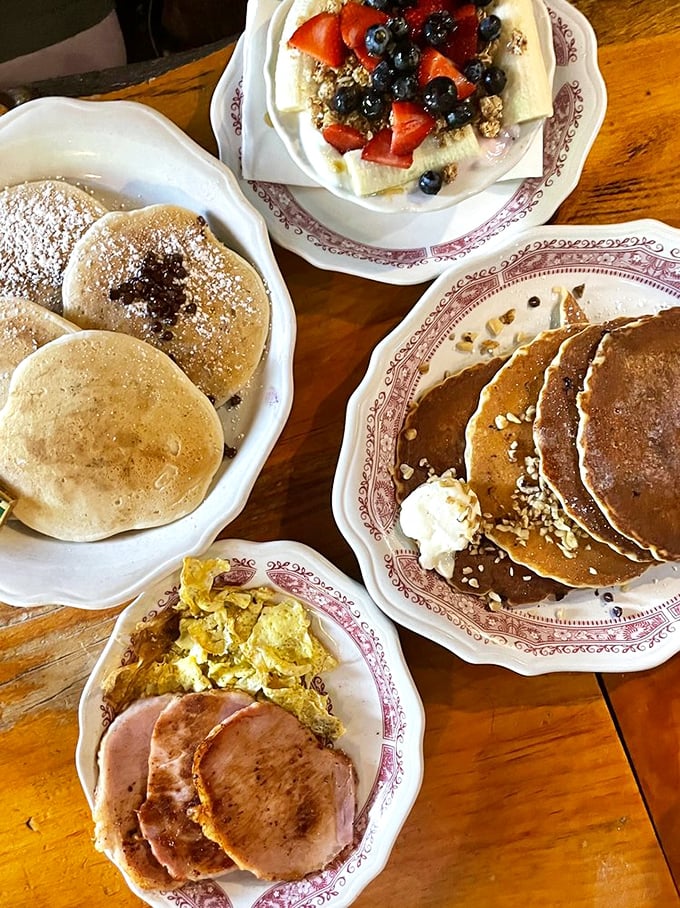 Breakfast perfection from every angle &ndash; golden pancakes, savory ham, fluffy eggs, and pure maple syrup waiting to transform your ordinary morning into something extraordinary.