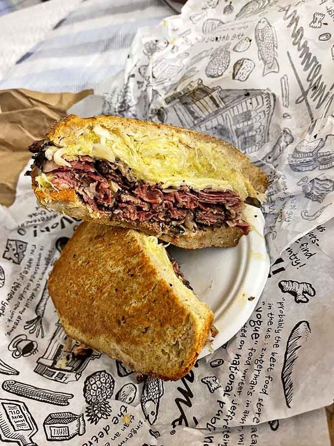 The Pastrami Reuben showcases meat so tender it practically surrenders to your bite, while sauerkraut and Swiss provide the perfect supporting cast.