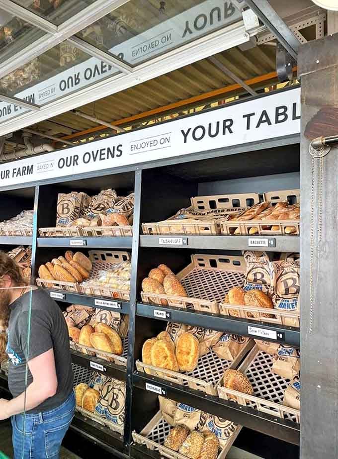 Bread architecture at its finest – shelves lined with loaves that deserve their own gallery exhibition.